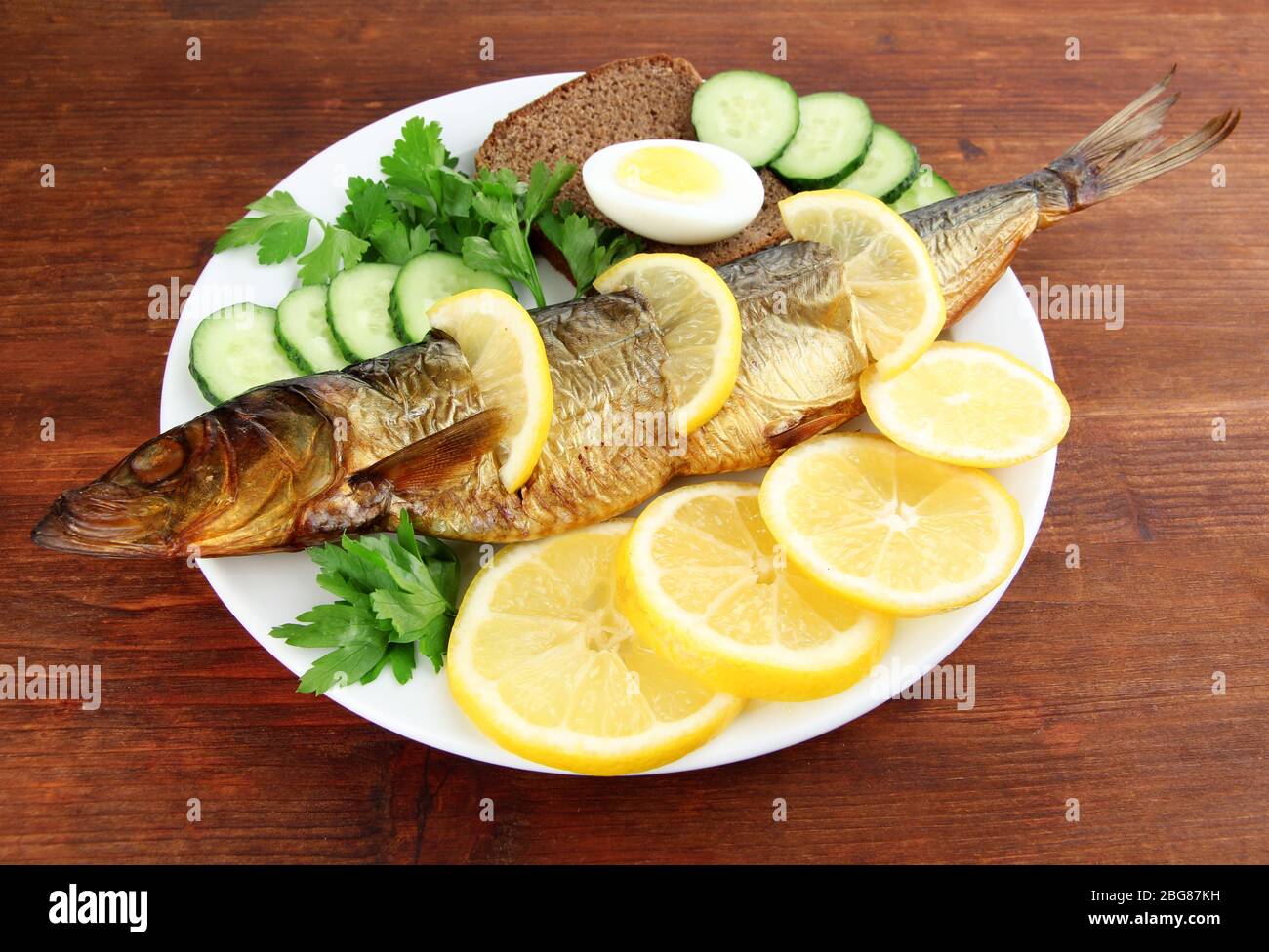 Smoked fish on plate close up Stock Photo - Alamy