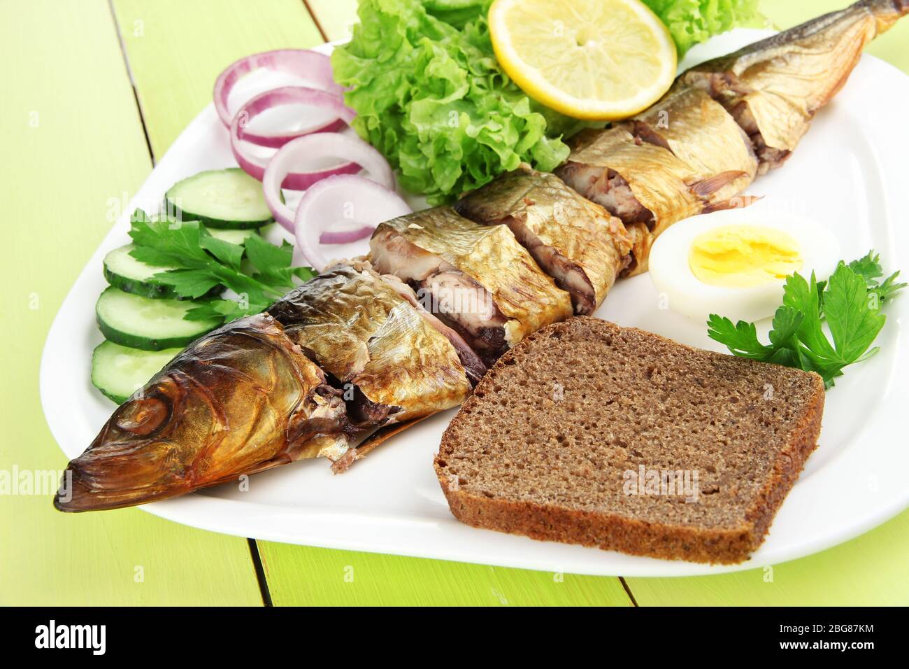 Smoked fish on plate close up Stock Photo - Alamy