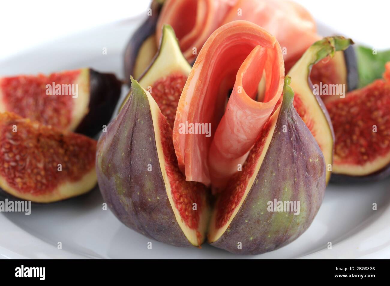 Tasty figs with ham, close up Stock Photo - Alamy