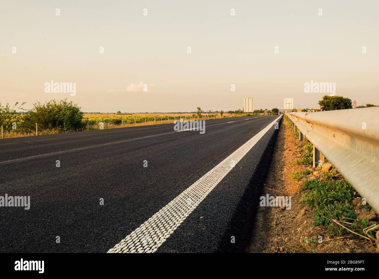 Empty Asphalt highway road stretching to the horizon at sunset Stock ...
