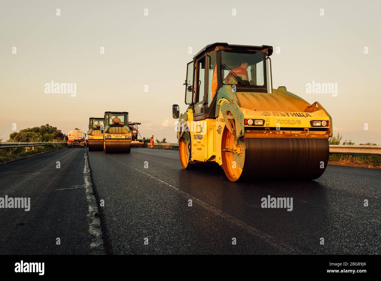 road roller applying a new asphalt surface. Asphalt paving construction site on a highway Stock ...