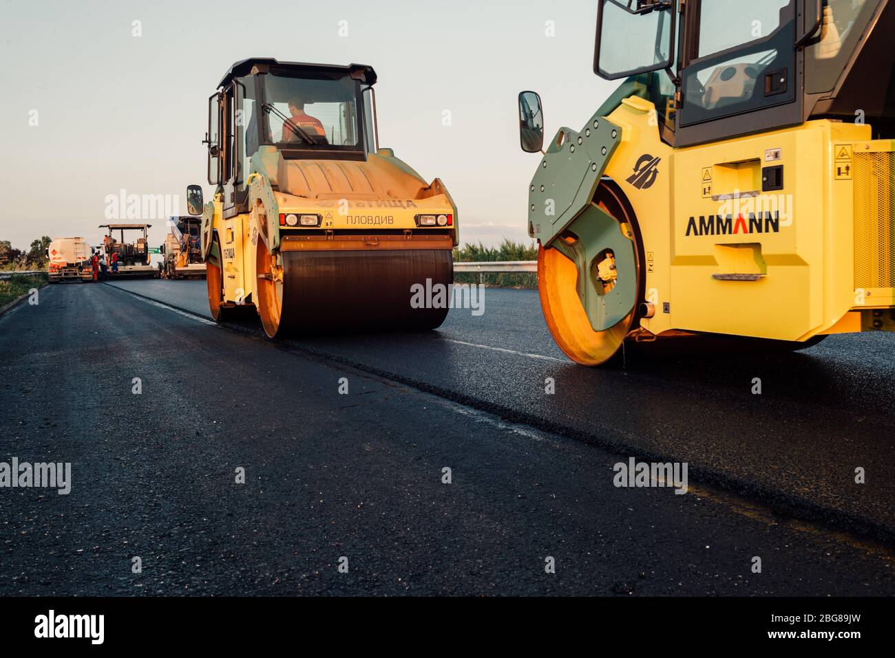 road roller applying a new asphalt surface. Asphalt paving construction ...