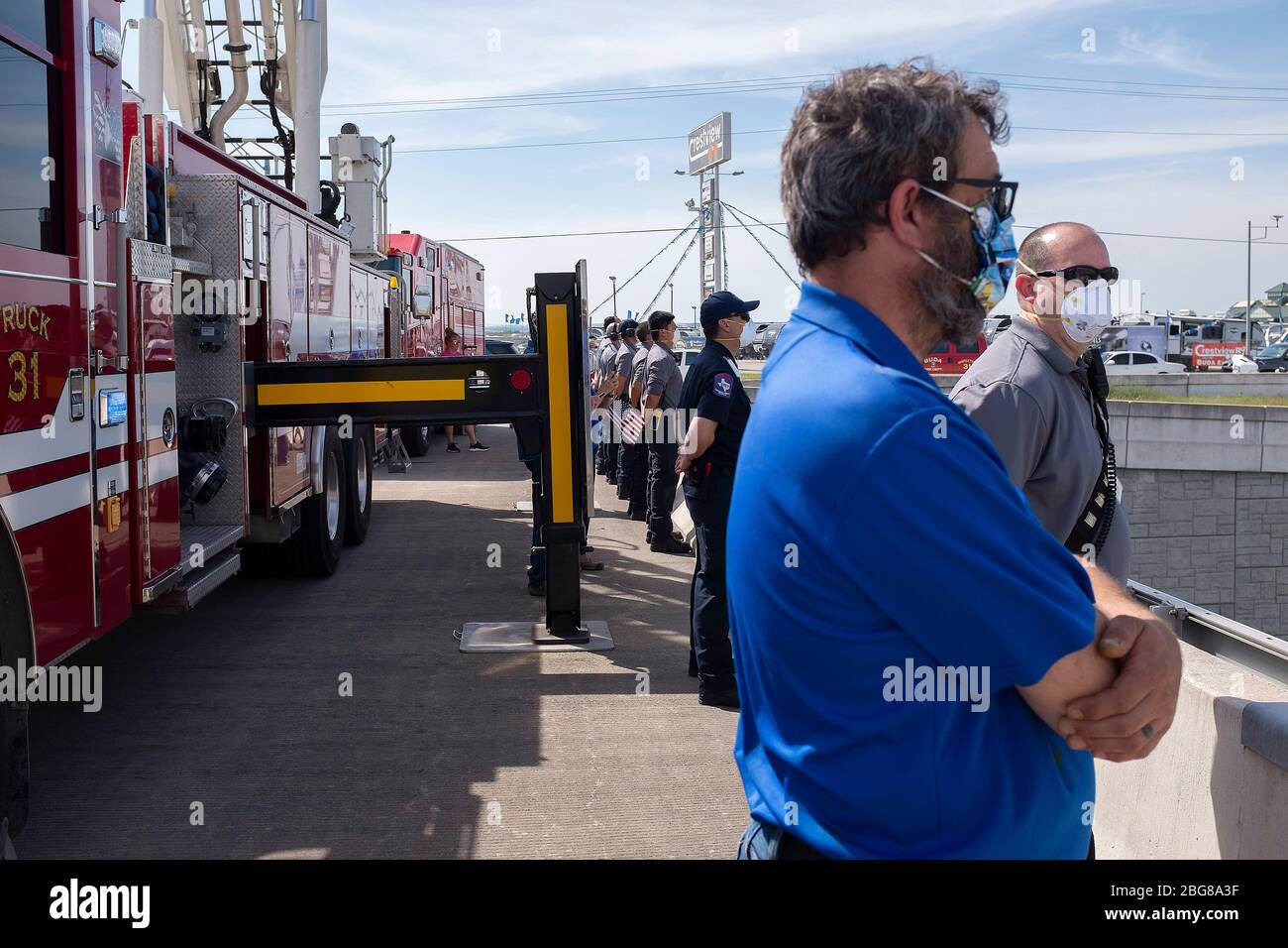 April 20, 2020: Firefighters with the Buda Fire Department stand at ...
