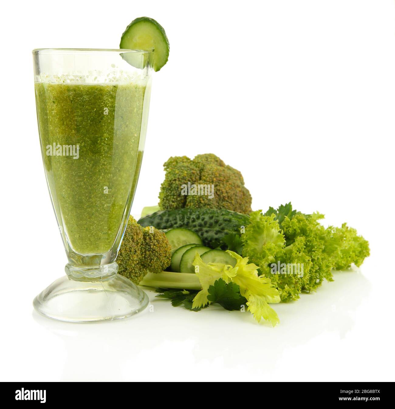 Glass of green vegetable juice and vegetables isolated on white Stock ...