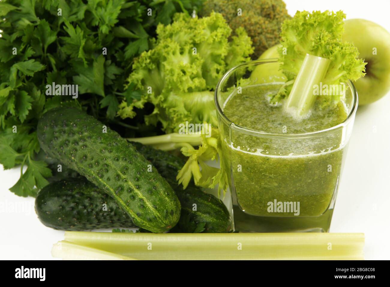 Glass of green vegetable juice and vegetables close up Stock Photo - Alamy