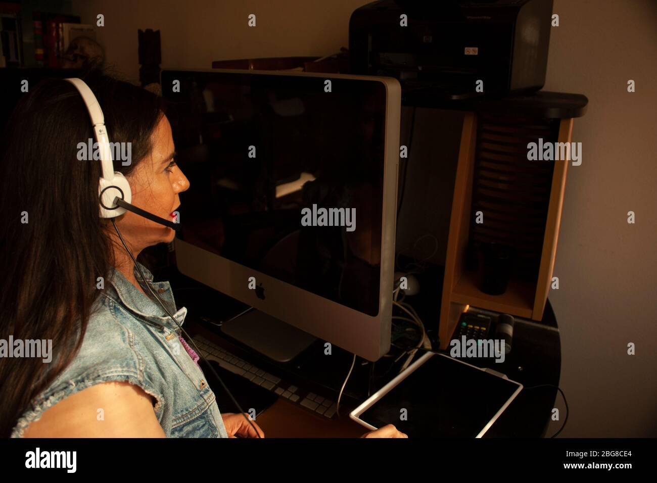 Female entrepreneur working in her office in front of the computer ...