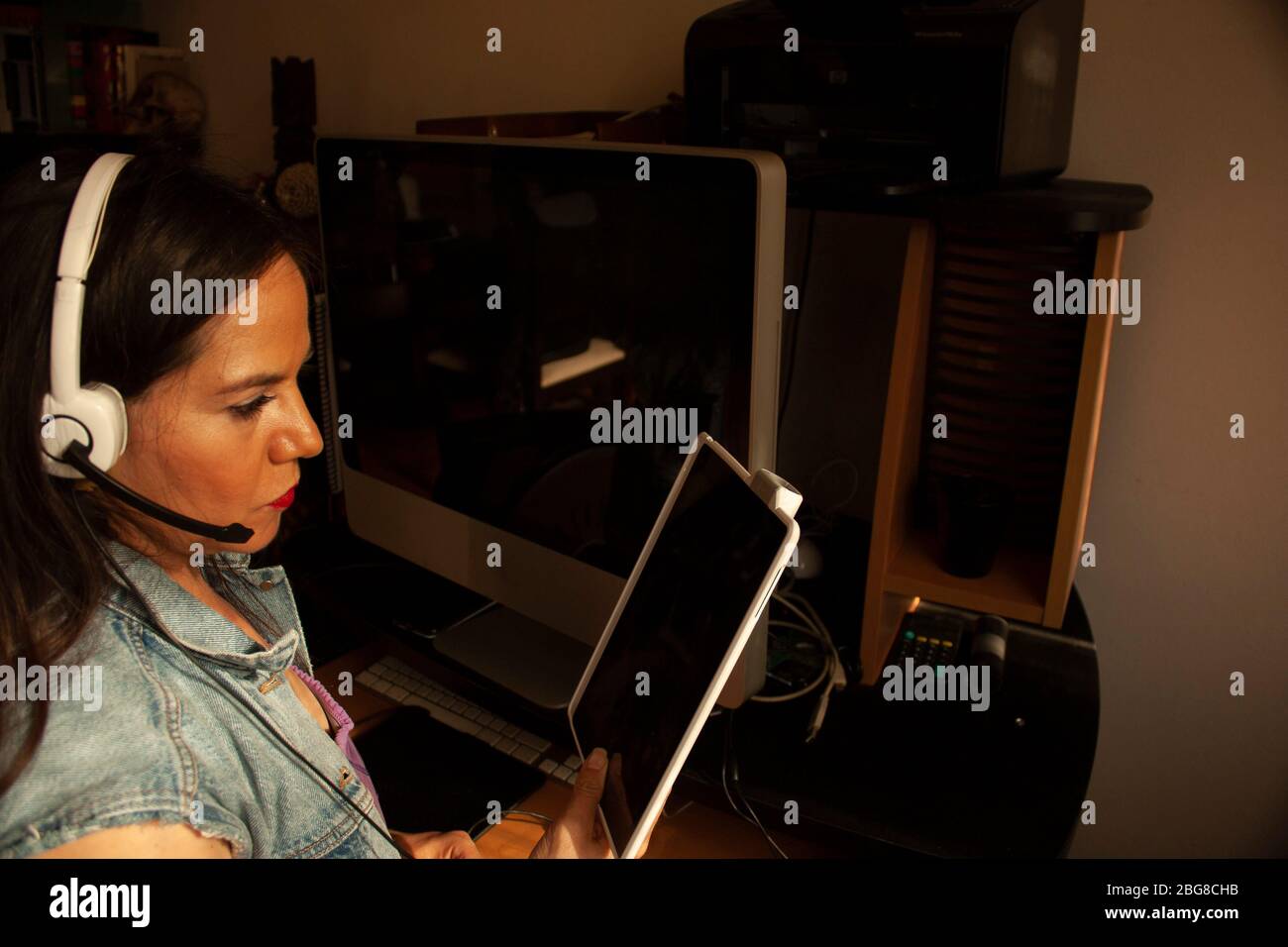 Mexican woman working from home doing home office in front working with ...