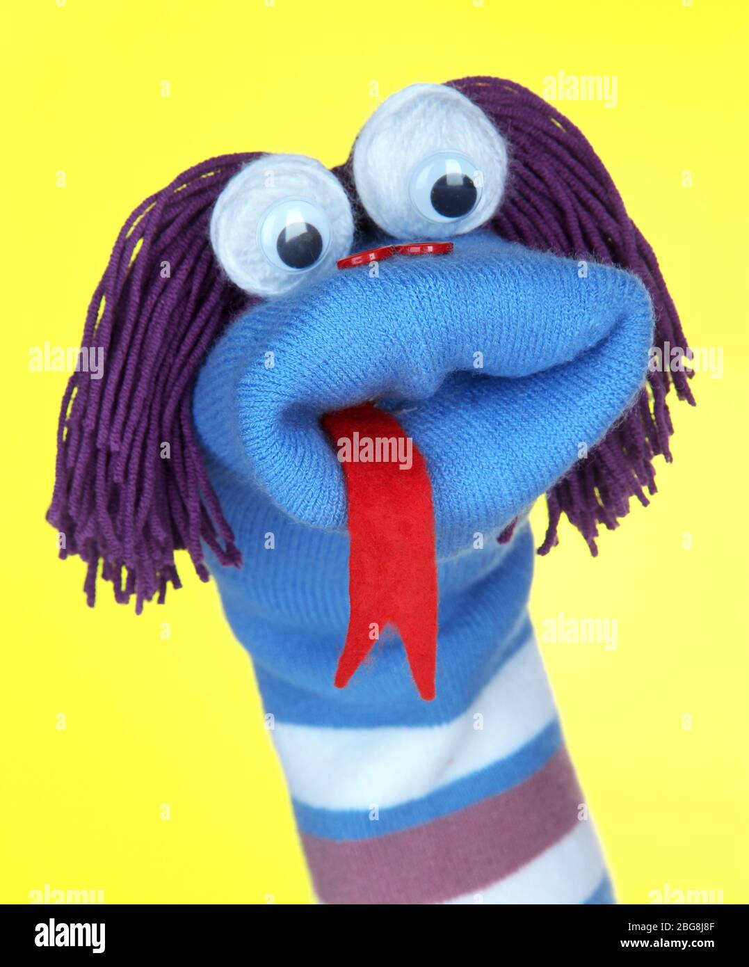 Cute sock puppet on yellow background Stock Photo - Alamy