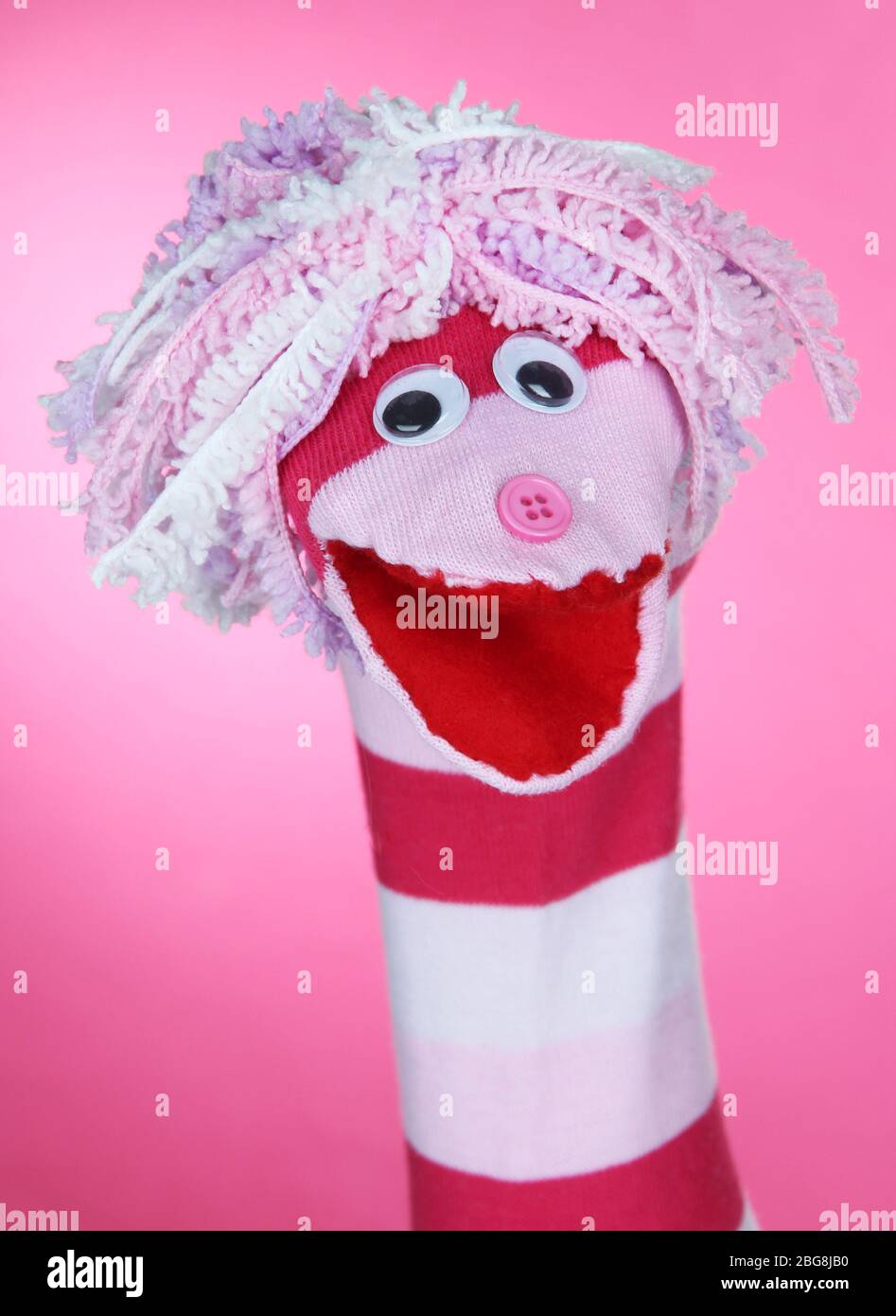 Cute sock puppet on pink background Stock Photo - Alamy