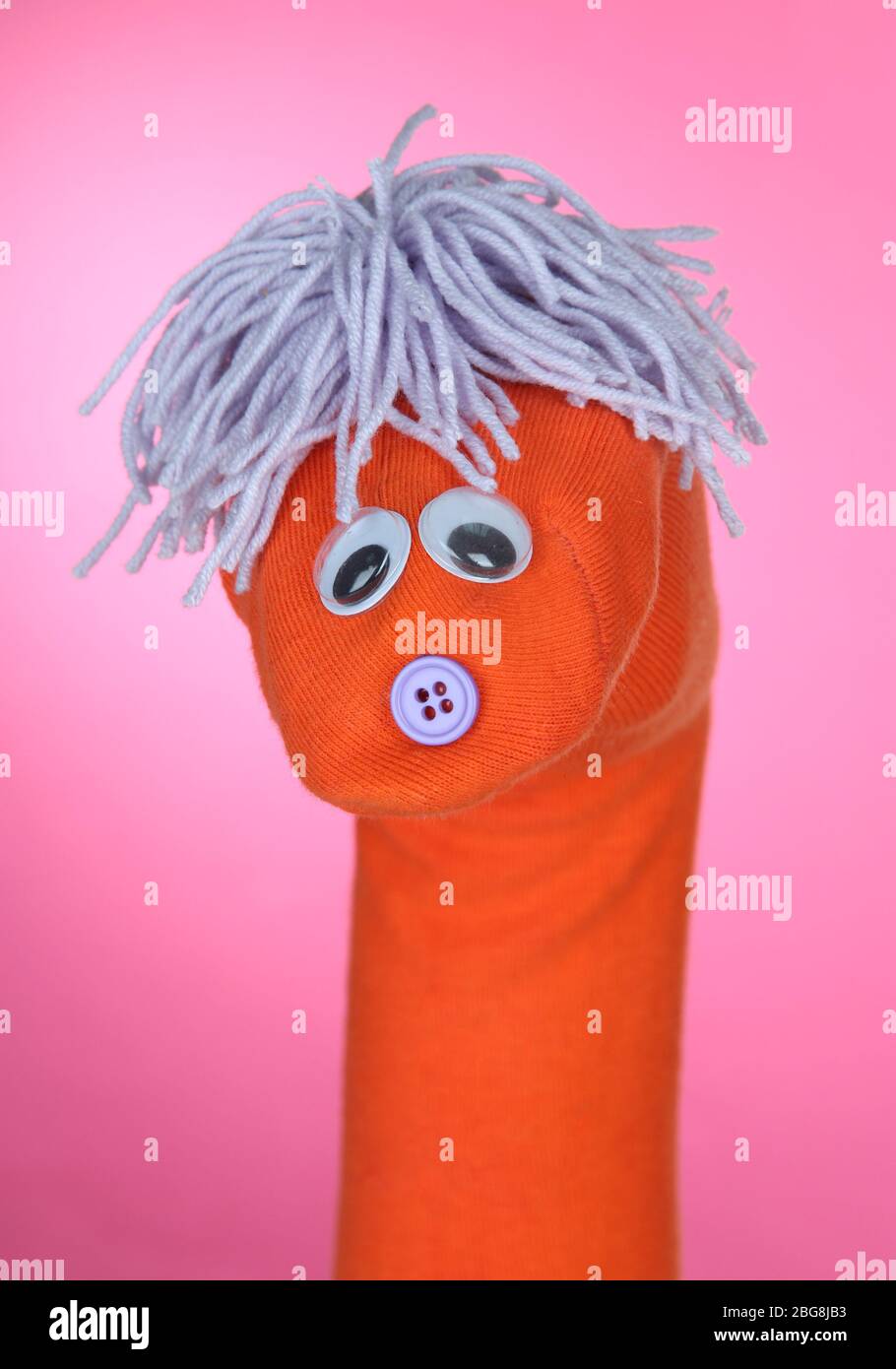 Cute sock puppet on pink background Stock Photo - Alamy