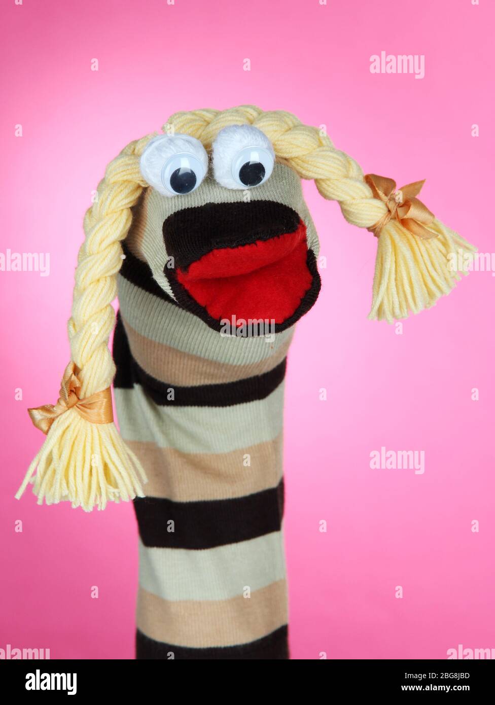 Cute sock puppet on pink background Stock Photo - Alamy
