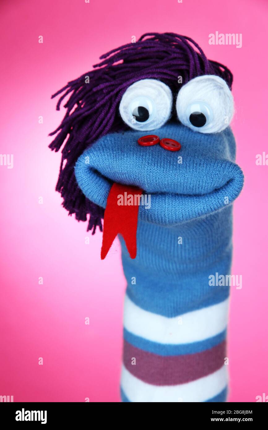 Cute sock puppet on pink background Stock Photo - Alamy