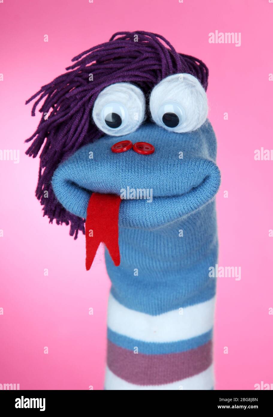 Cute sock puppet on pink background Stock Photo - Alamy