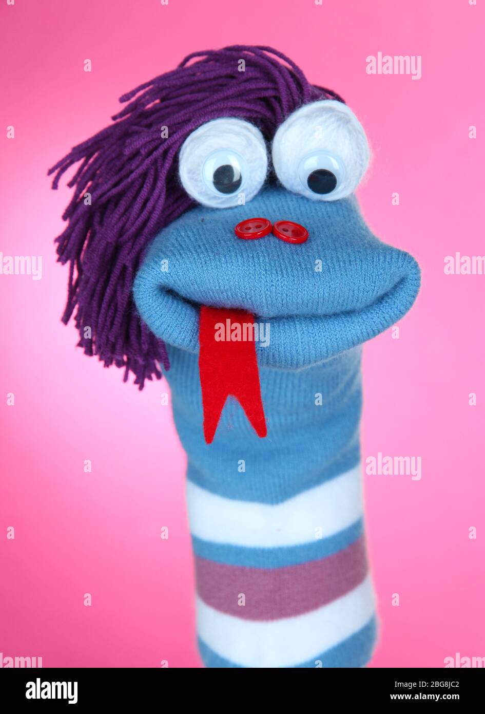 Cute sock puppet on pink background Stock Photo - Alamy