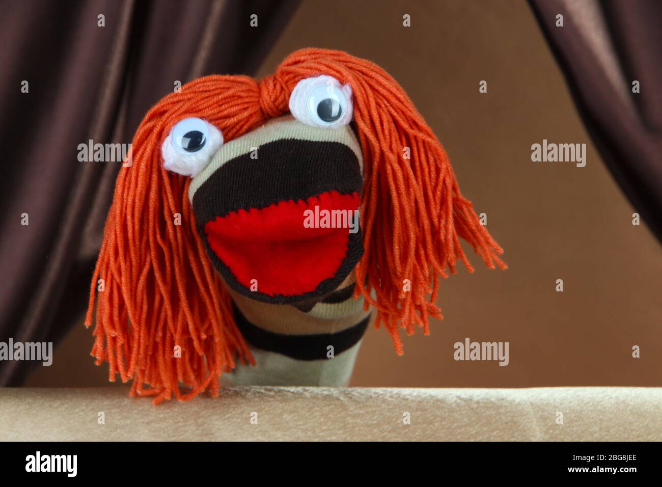 Puppet show on brown background Stock Photo - Alamy
