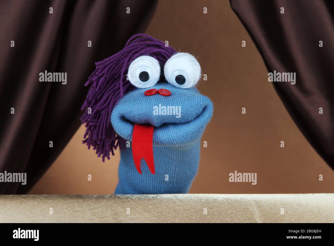 Puppet show on brown background Stock Photo - Alamy