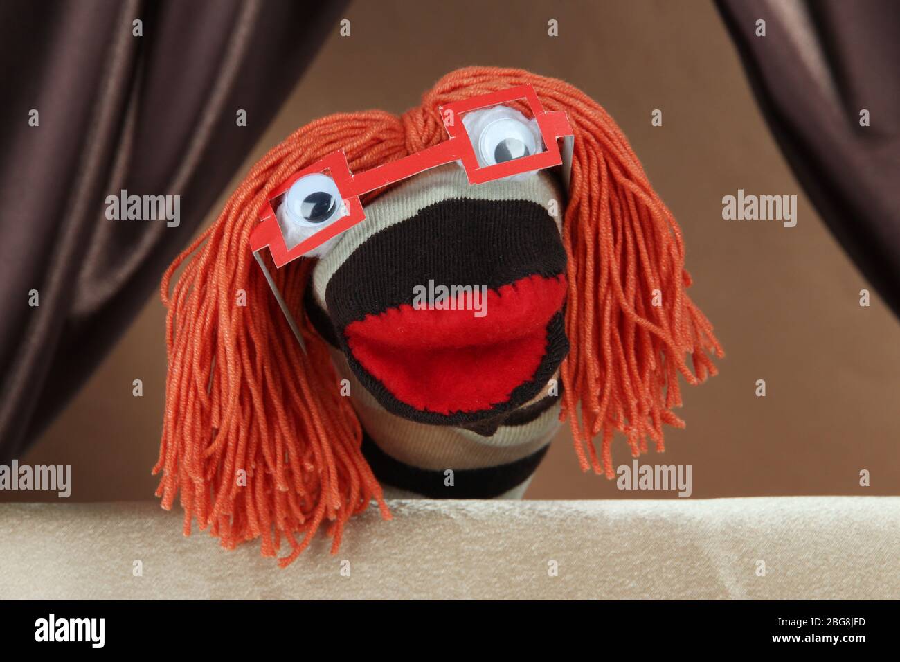 Puppet show on brown background Stock Photo - Alamy