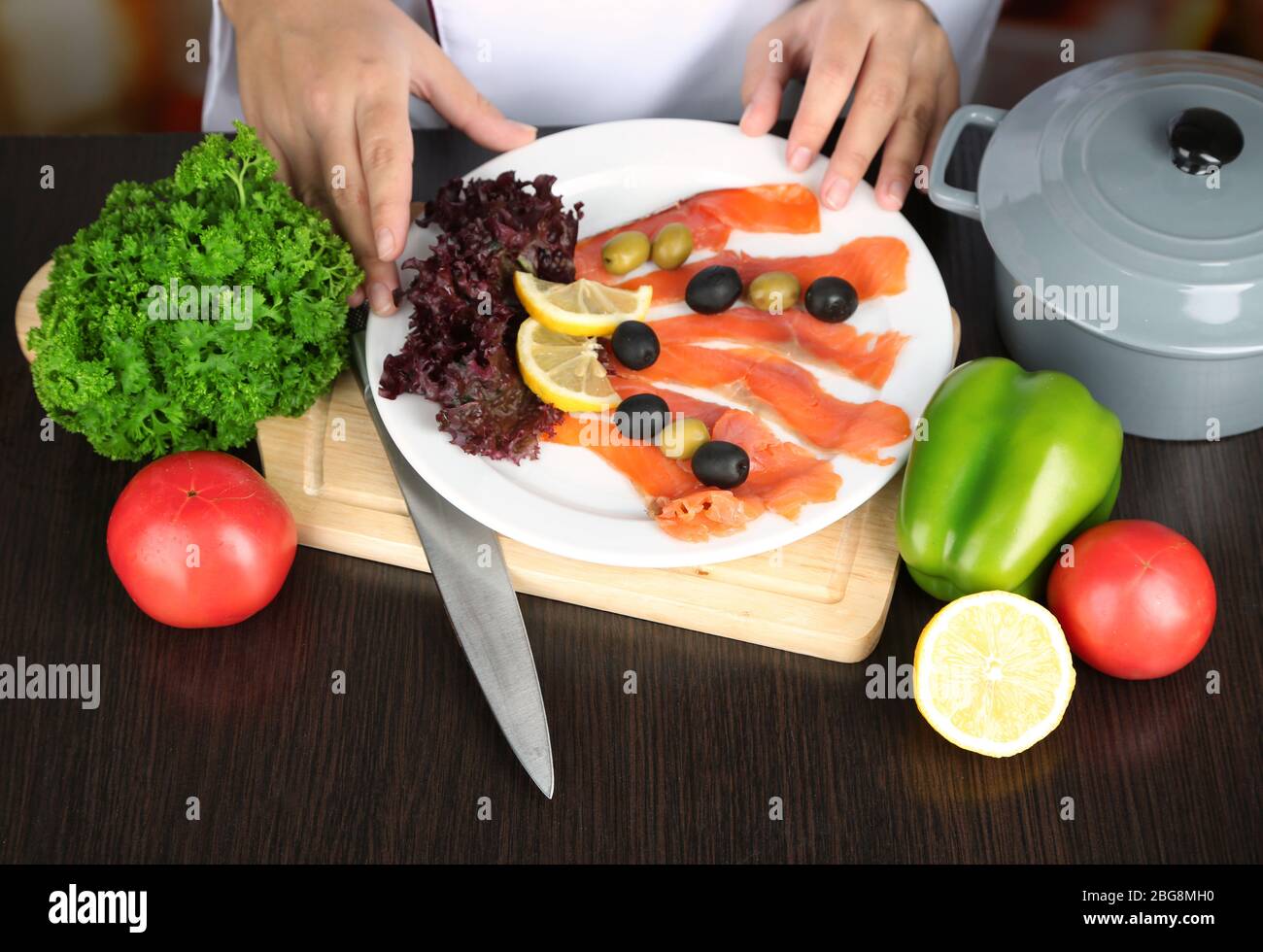 Cook hands decorating dish Stock Photo - Alamy