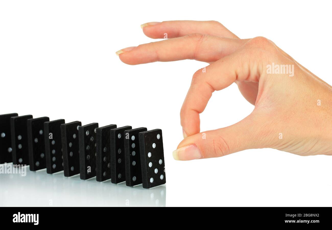 Hand pushing dominoes isolated on white Stock Photo - Alamy