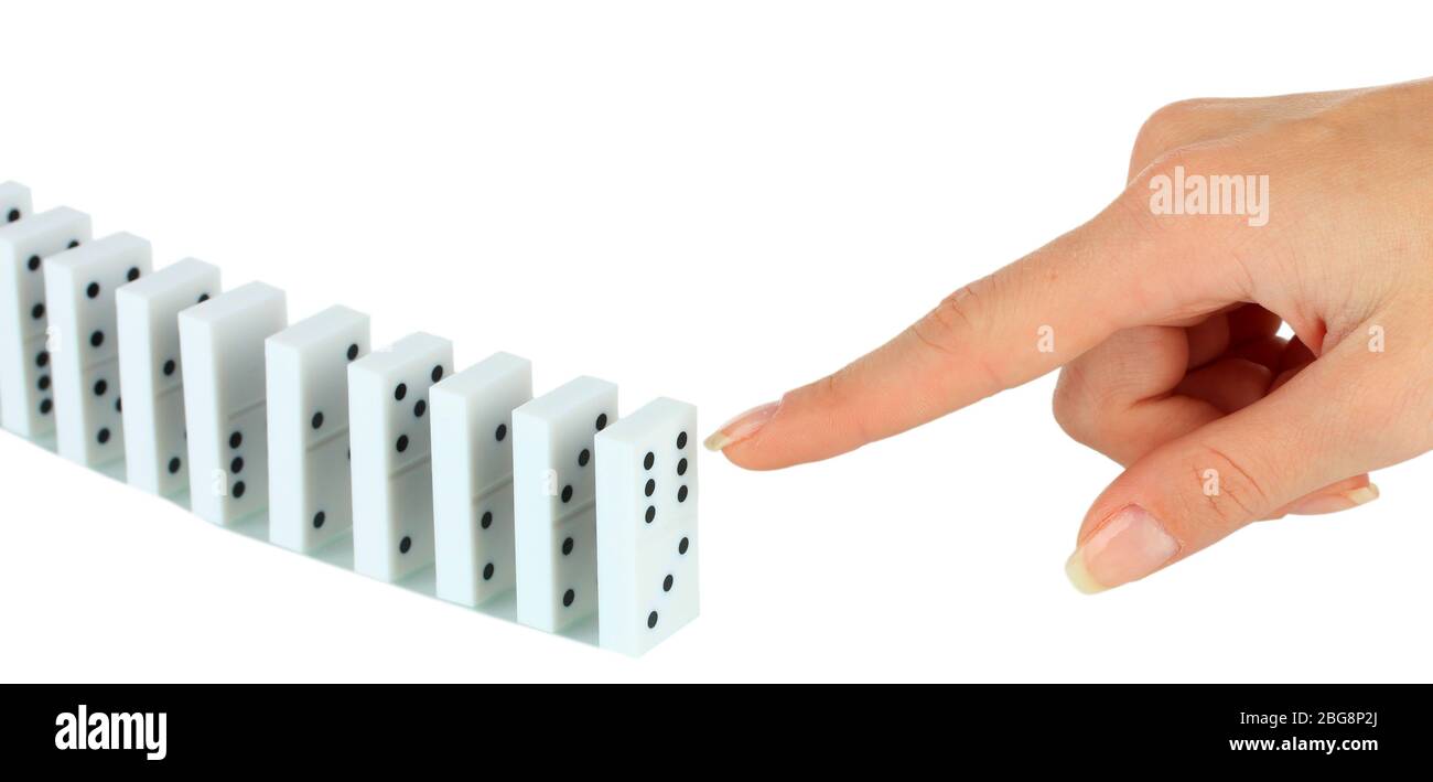 Hand pushing dominoes isolated on white Stock Photo - Alamy