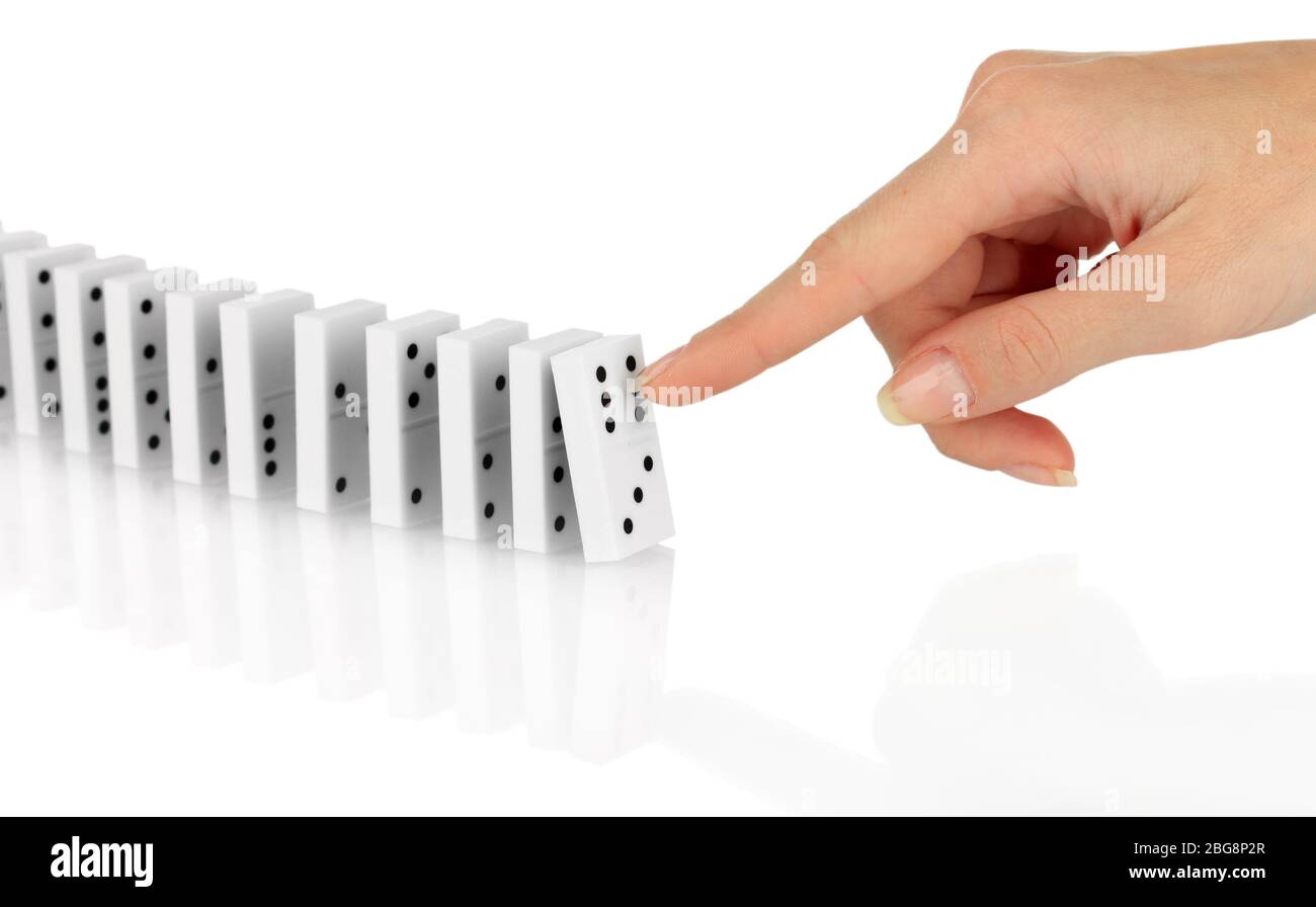 Hand pushing dominoes isolated on white Stock Photo - Alamy
