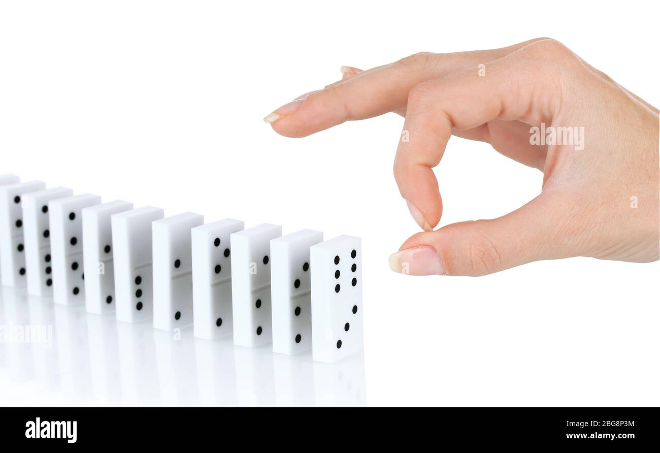 Hand pushing dominoes isolated on white Stock Photo - Alamy