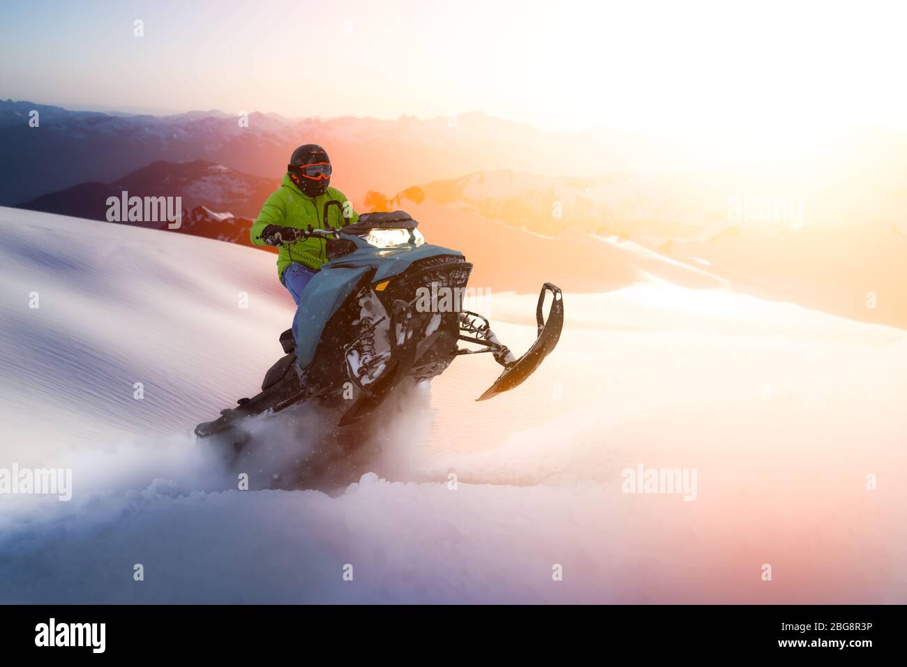Adventurous Man Riding a Snowmobile Stock Photo - Alamy