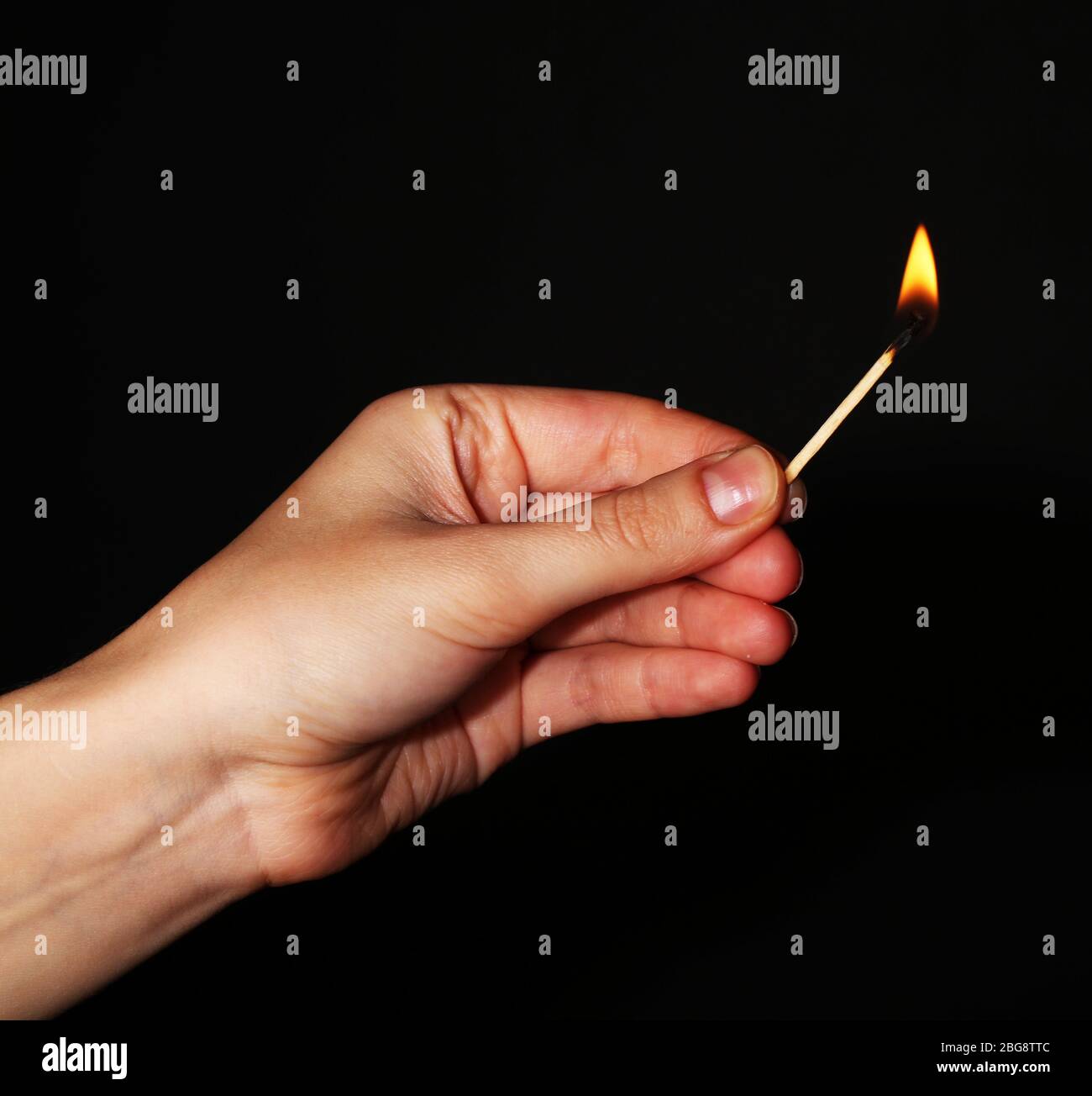 Burning match in hand on black background Stock Photo - Alamy