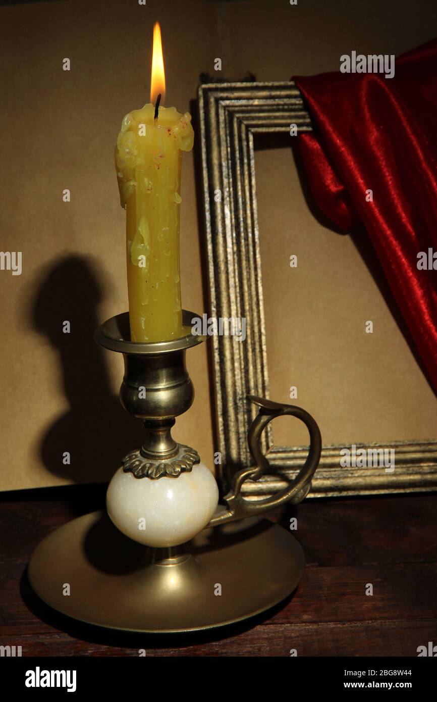 Old candle on table in room Stock Photo - Alamy