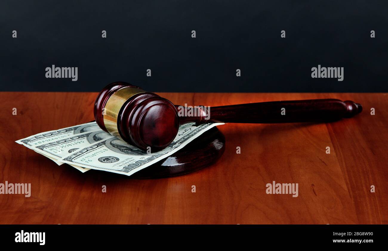 Gavel and money on table on black background Stock Photo - Alamy