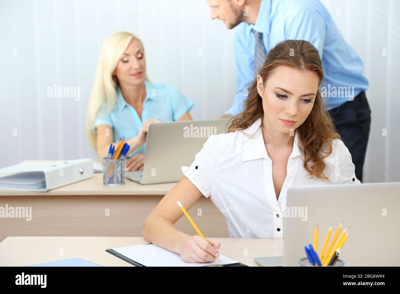 Office workers in workplace Stock Photo - Alamy