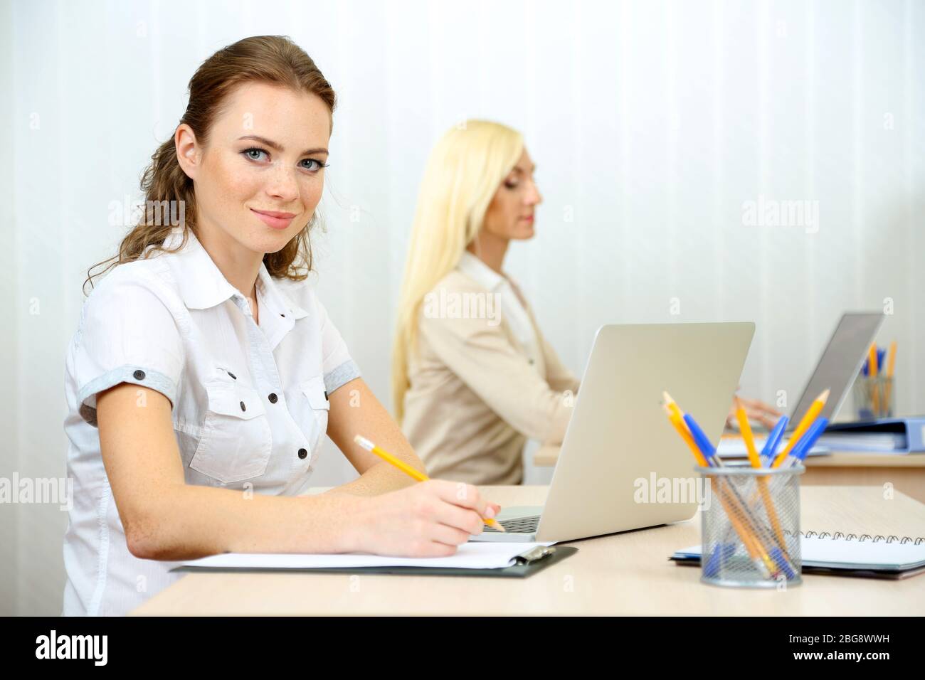 Woman in office at workplace Stock Photo - Alamy