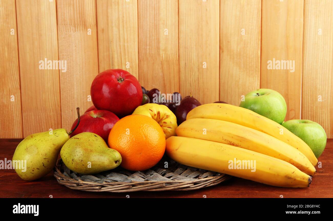 Composition of different fruits on table on wooden background Stock ...