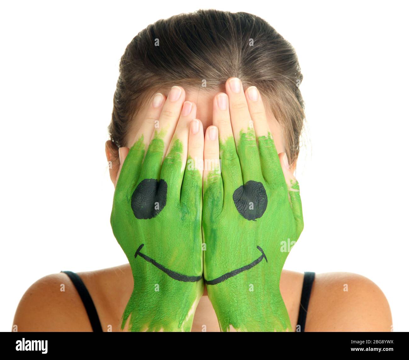 Portrait of girl hiding her face under smile mask isolated on white ...