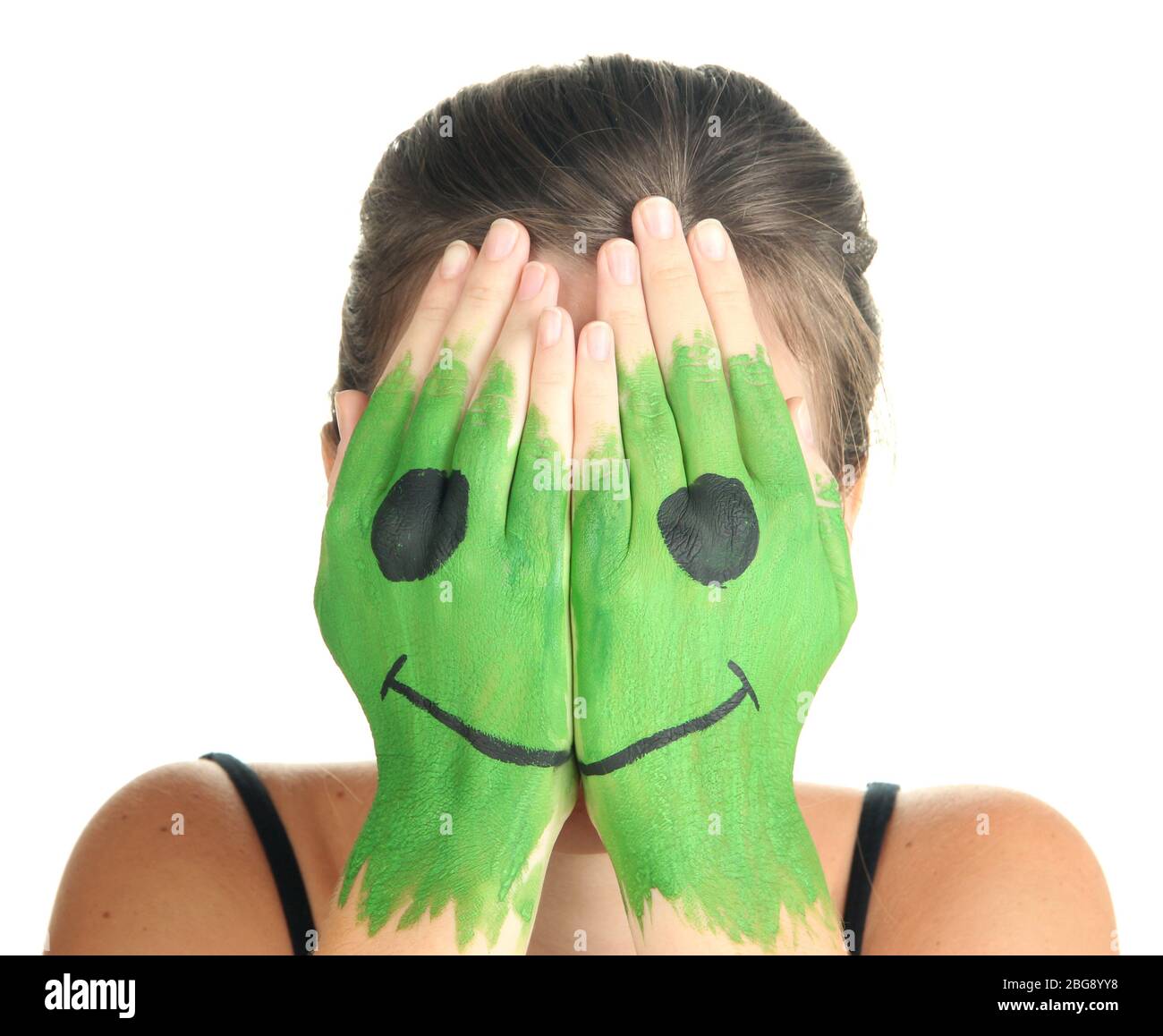 Portrait of girl hiding her face under smile mask isolated on white ...