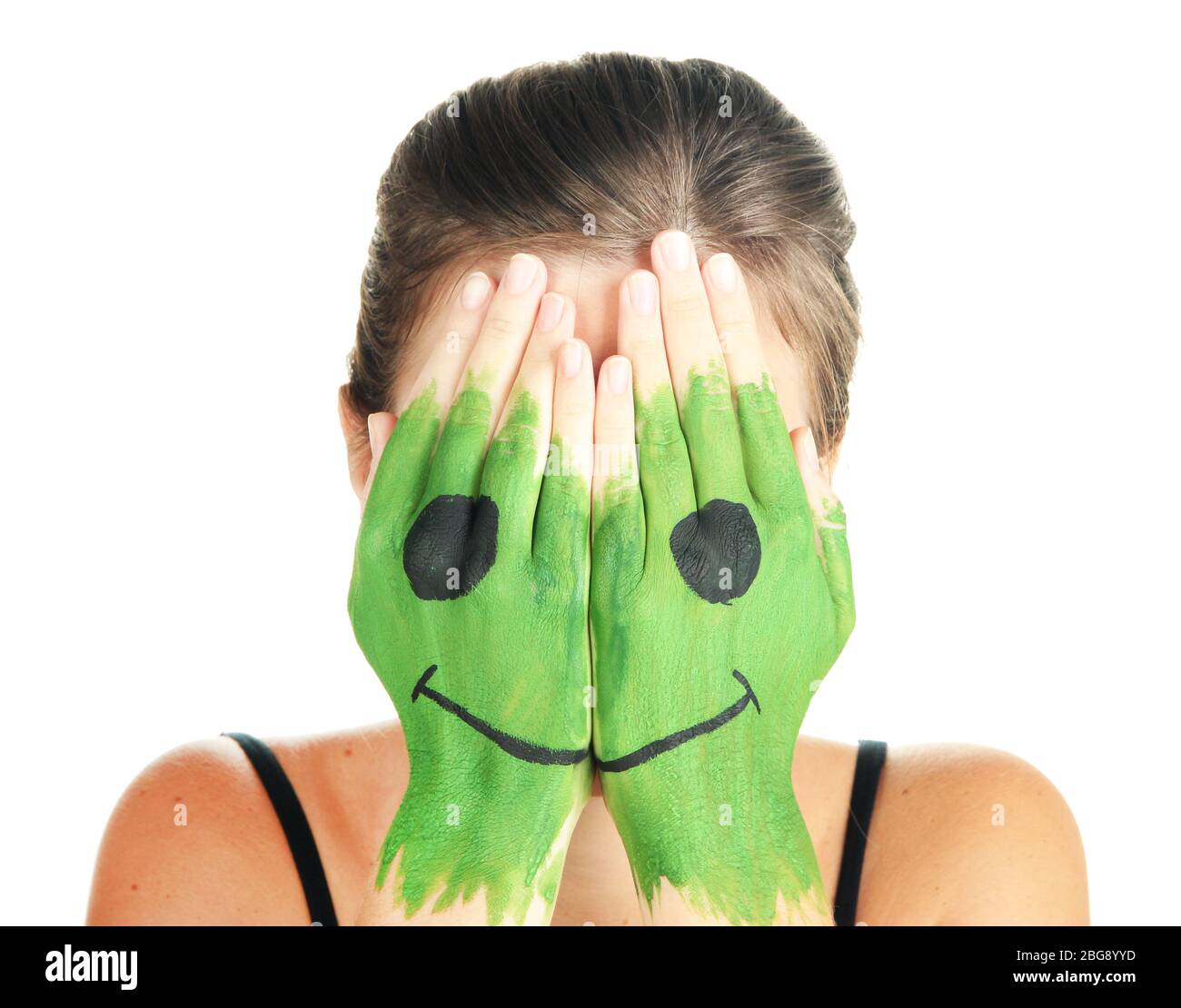 Portrait of girl hiding her face under smile mask isolated on white ...