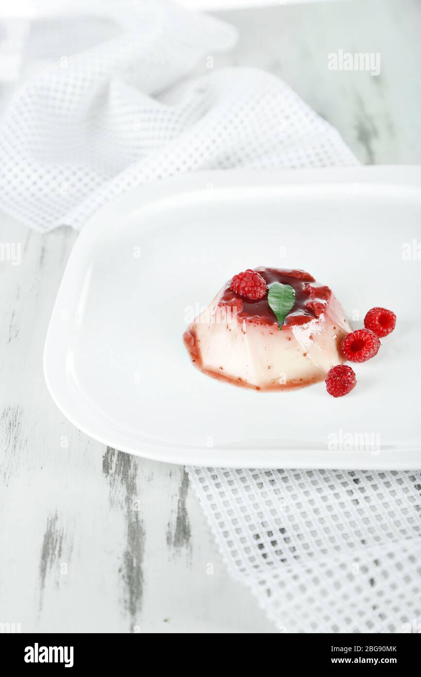 Panna Cotta with raspberry sauce, on wooden background Stock Photo - Alamy