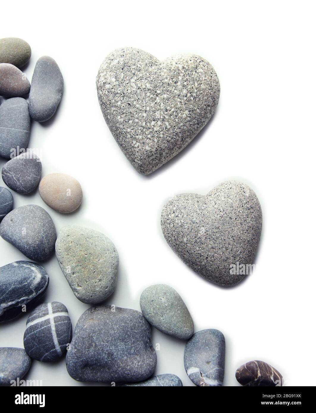 Grey stones in shape of heart, isolated on white Stock Photo - Alamy