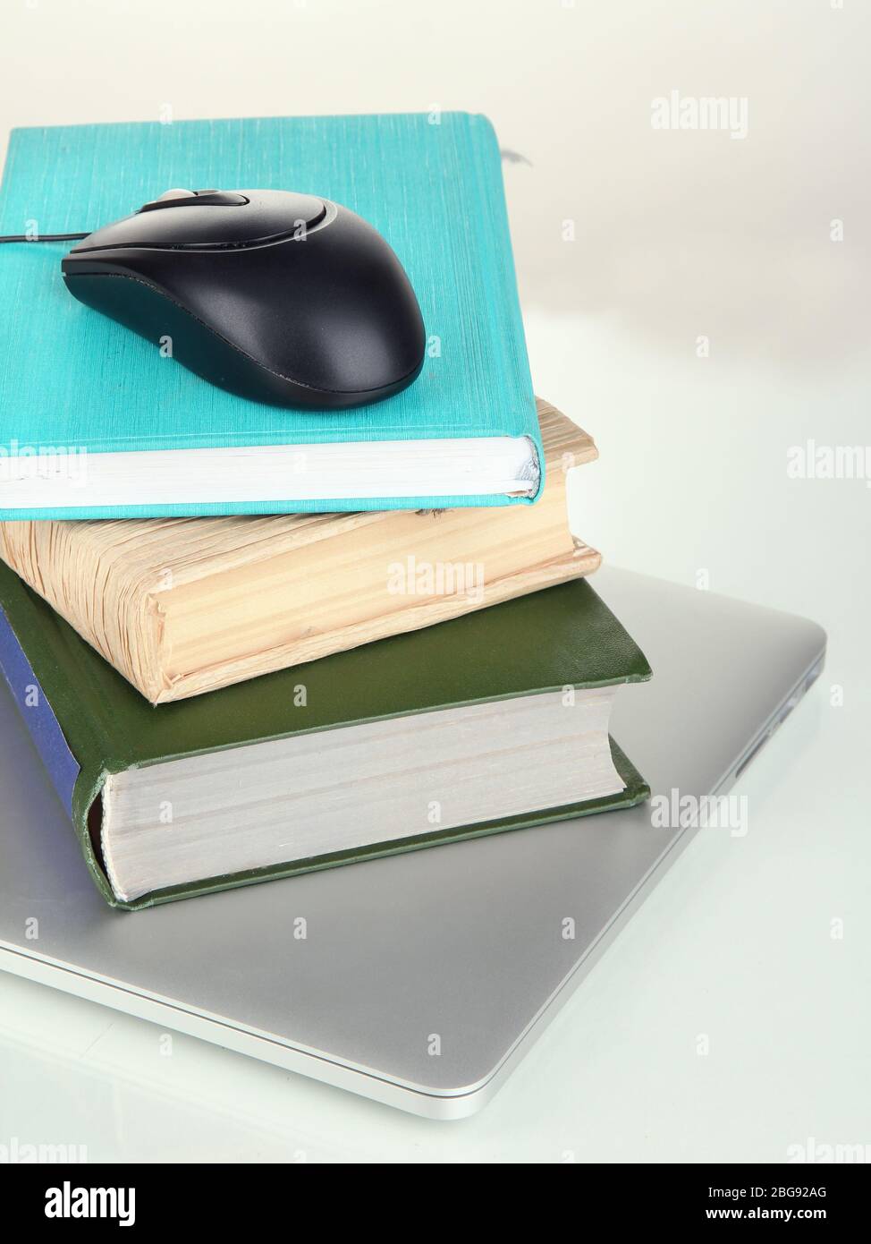 Computer mouse on books and notebook isolated on white Stock Photo - Alamy