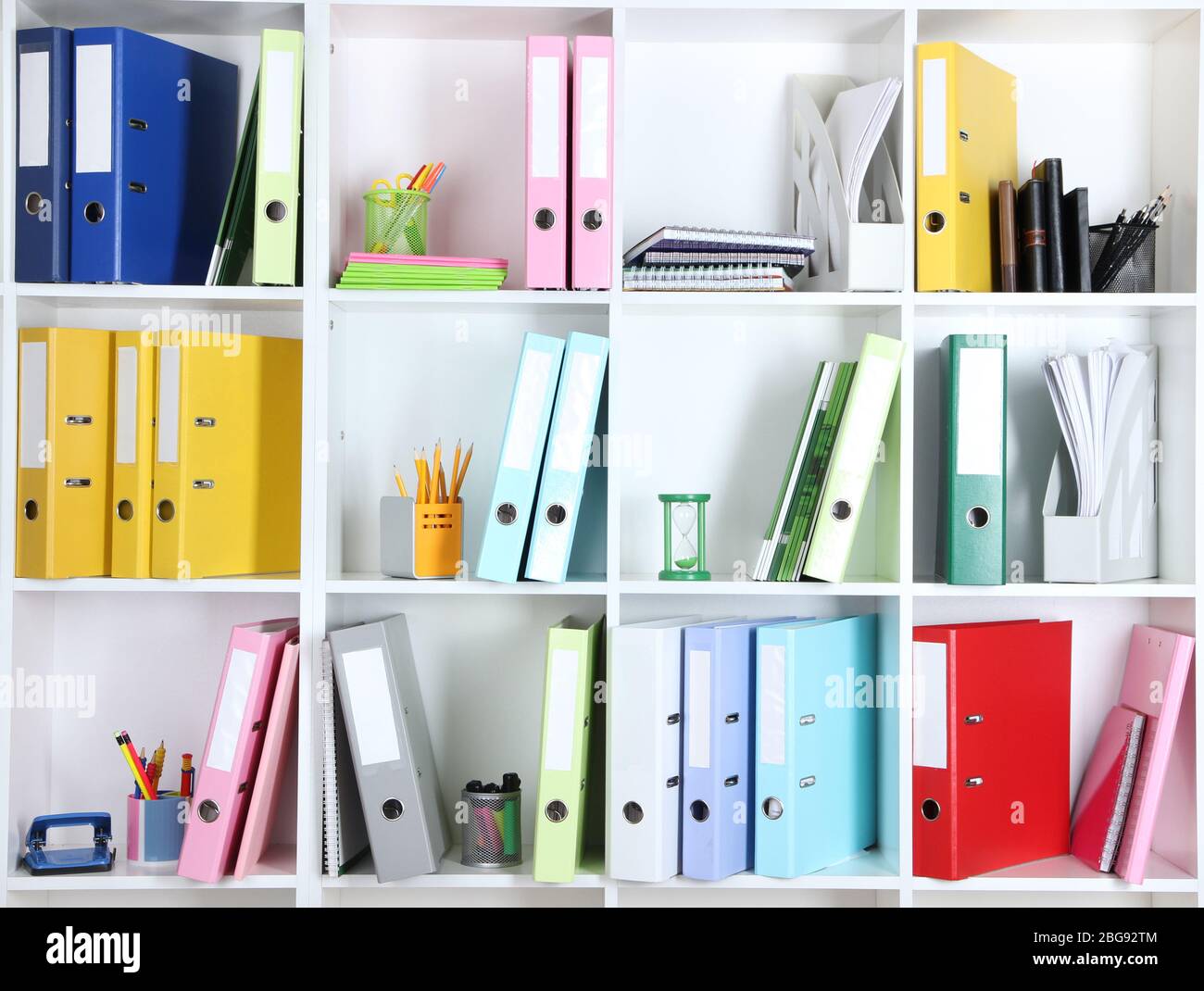 White office shelves with folders and different stationery, close up ...