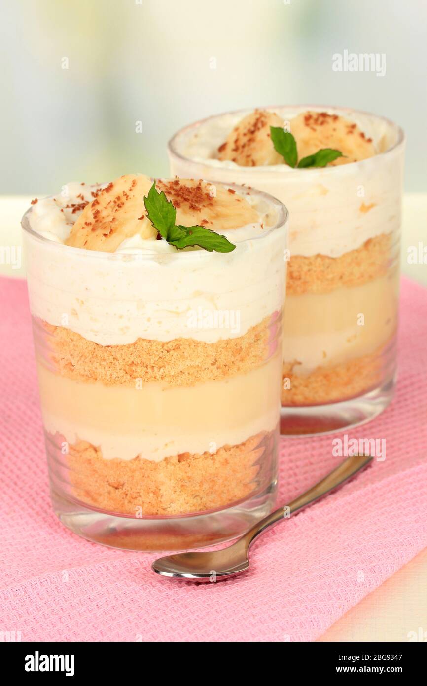 Delicious dessert with banana and caramel on table on light background ...