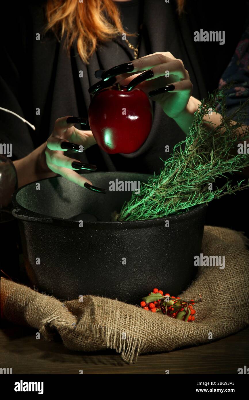 Witch in scary Halloween laboratory on dark color background Stock ...