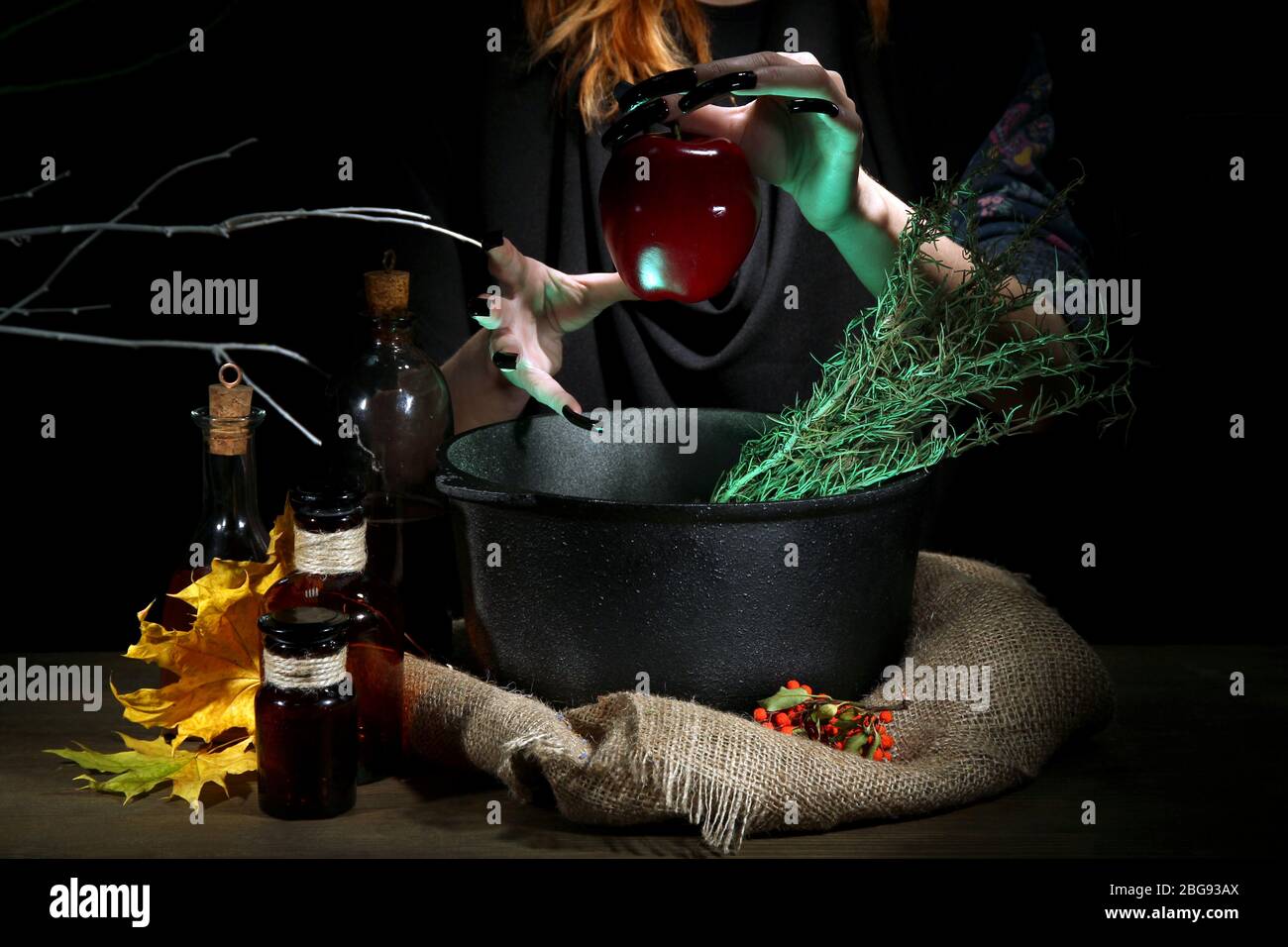Witch in scary Halloween laboratory on dark color background Stock ...