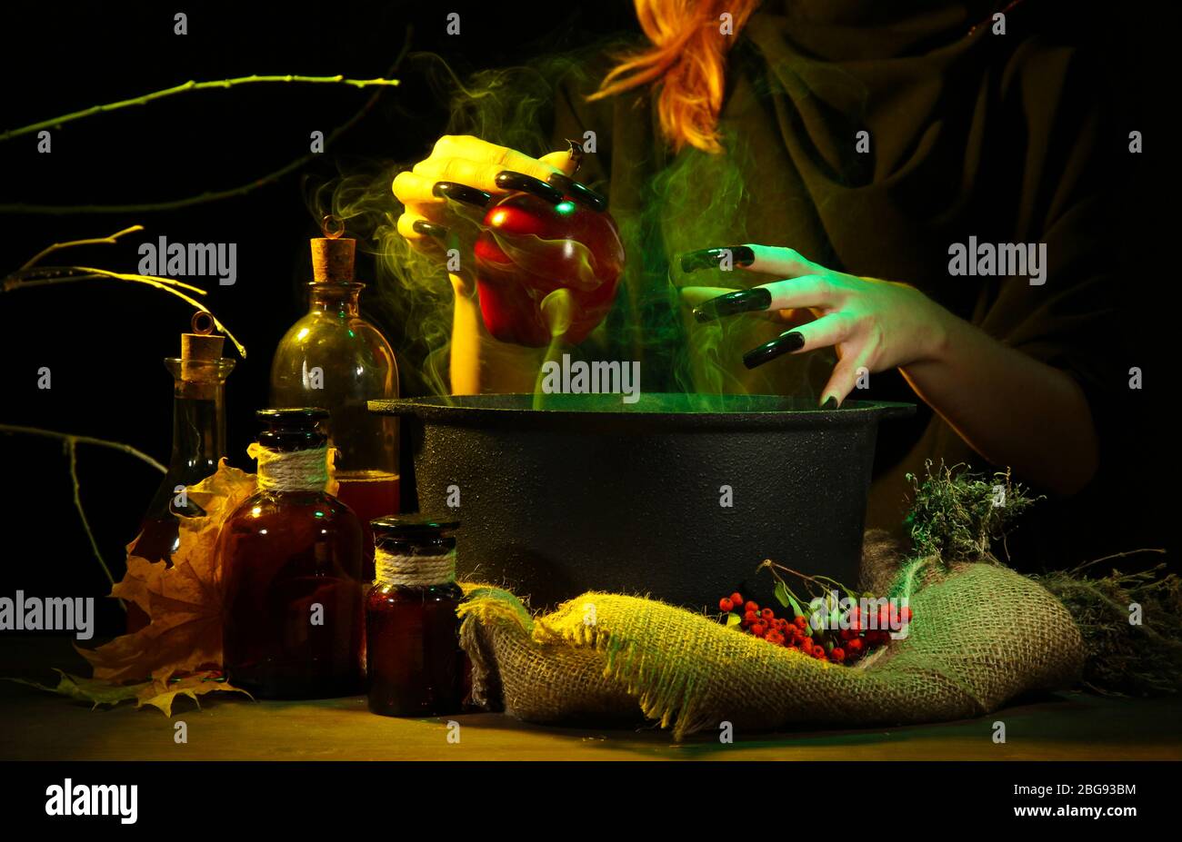 Witch in scary Halloween laboratory on dark color background Stock ...