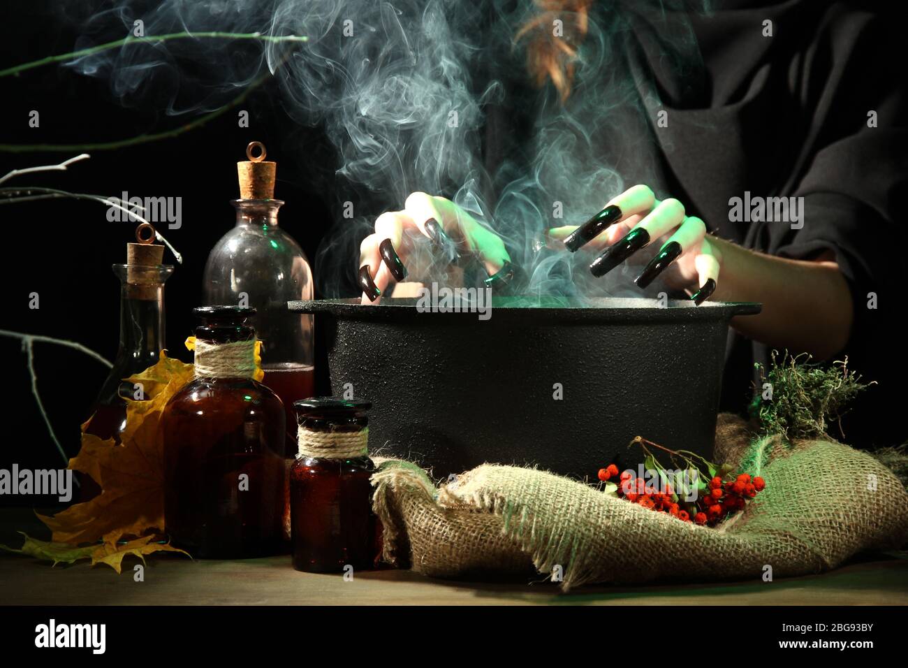 Witch in scary Halloween laboratory on dark color background Stock ...