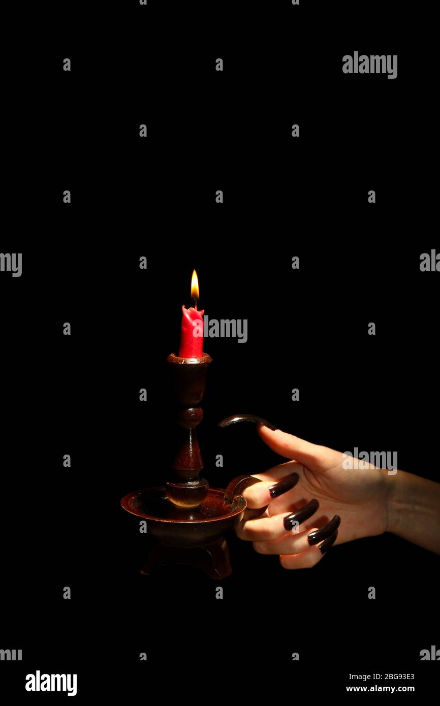 Hand with candle , isolated on black Stock Photo - Alamy