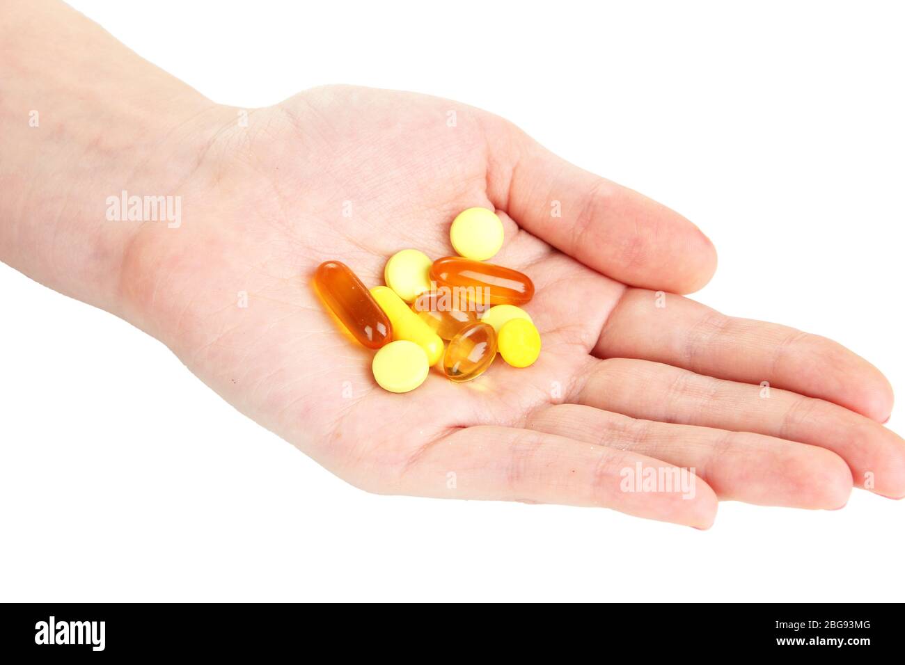 Pills in hand isolated on white Stock Photo - Alamy