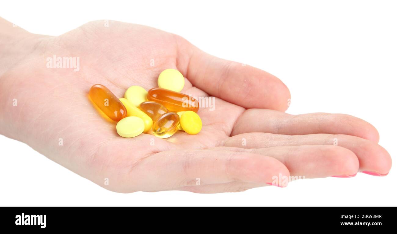 Pills in hand isolated on white Stock Photo - Alamy