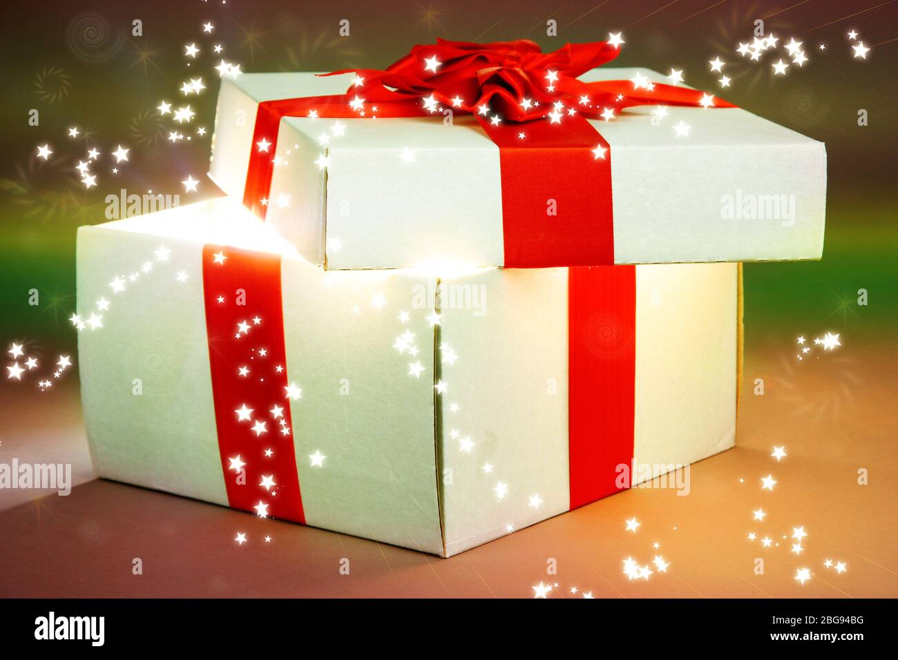 Gift box with bright light on it on bright background Stock Photo - Alamy