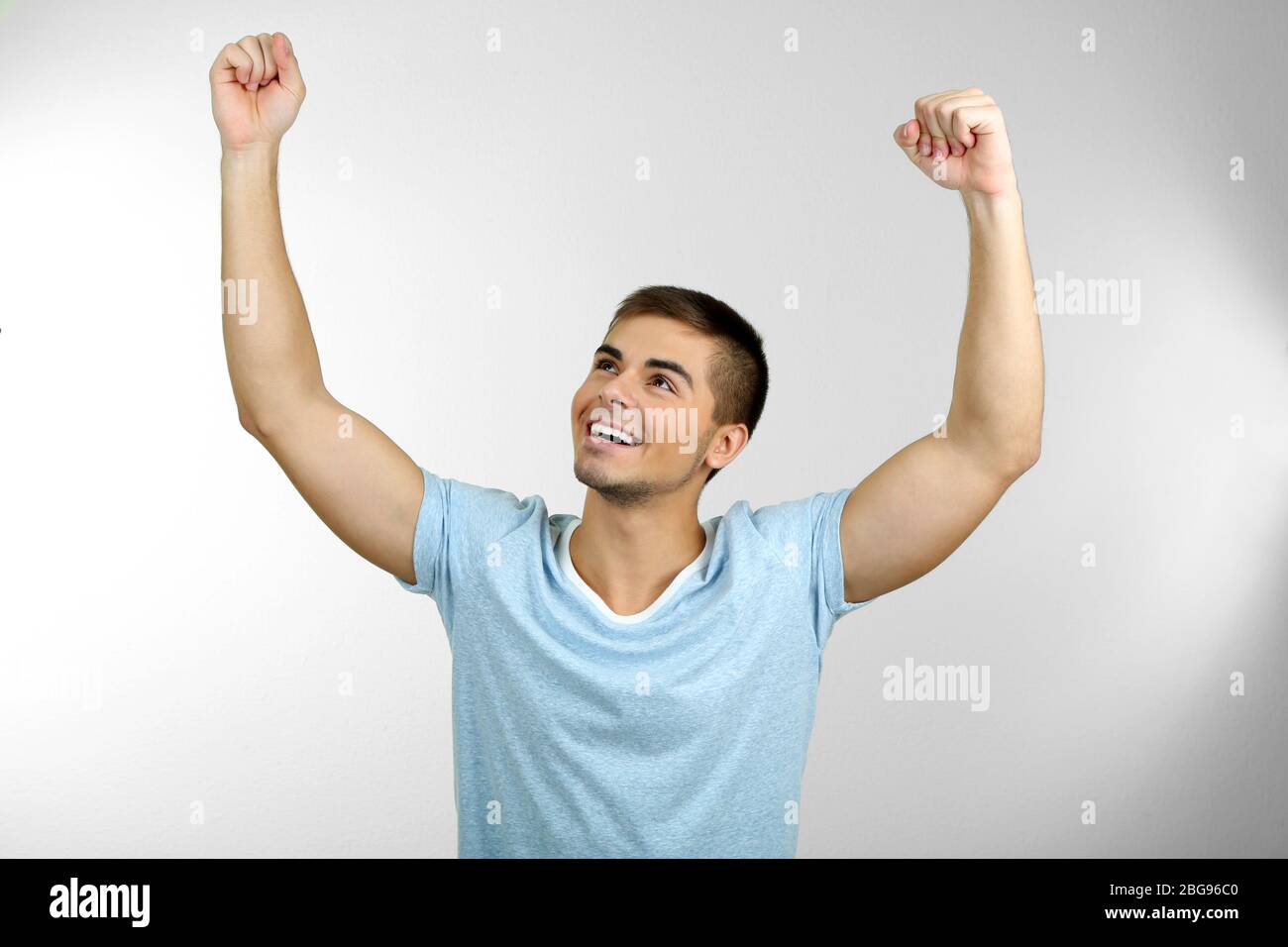 Portrait of young man on grey background Stock Photo - Alamy